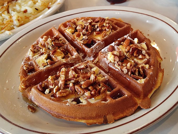 The famous pecan waffle arrives like edible architecture&mdash;golden, crisp exterior giving way to fluffy interior, with pecans distributed with mathematical precision.