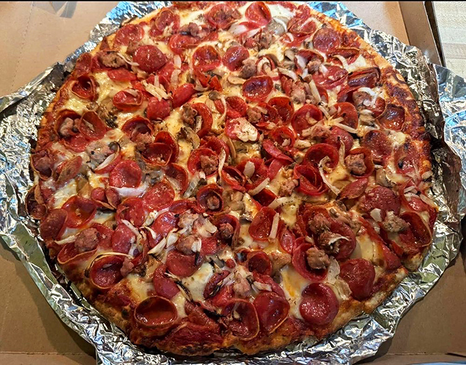 Pepperoni and sausage blanket this thin-crust masterpiece like a delicious edible quilt of pure happiness.