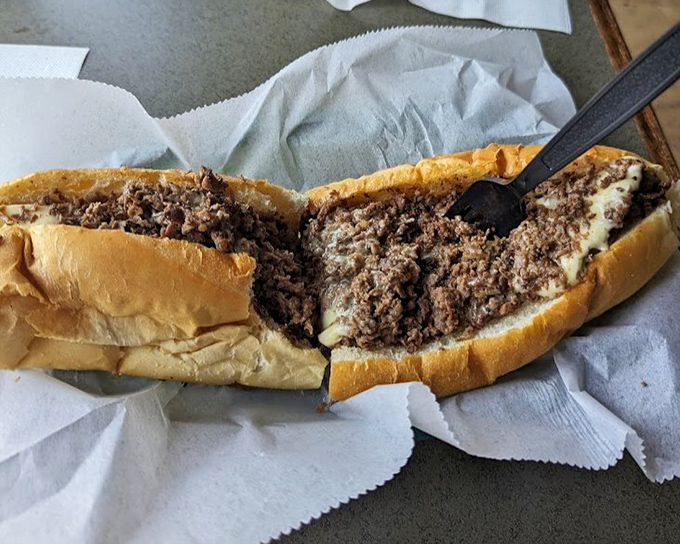 Behold, the perfect marriage of beef and cheese, where thinly sliced ribeye meets its melty soulmate in a roll that's both pillow and fortress.