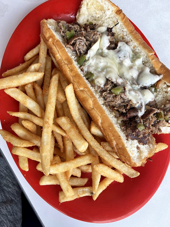 The Philly cheesesteak doesn't just arrive&mdash;it makes an entrance. Tender beef, melty cheese, and those perfectly golden fries deserve their own red carpet.