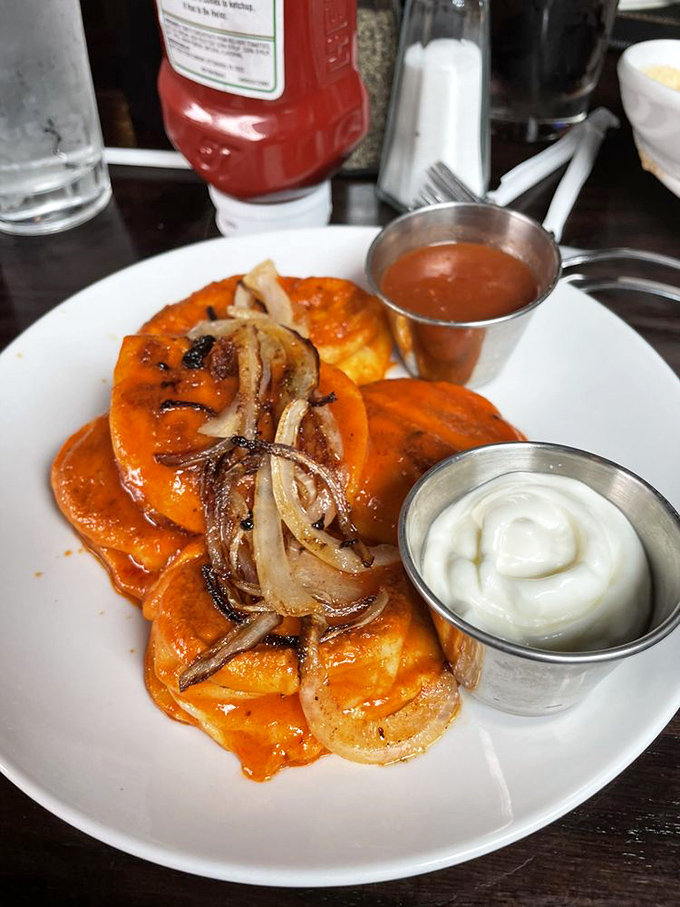 These golden pierogies aren't just food; they're edible history, topped with perfectly caramelized onions and served with the requisite dollops of sour cream and love.