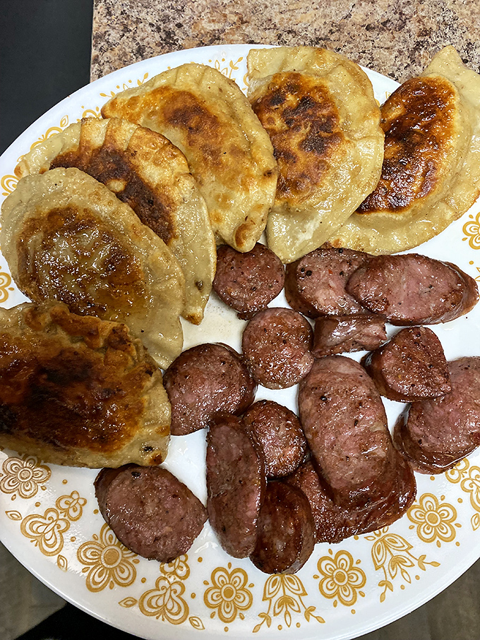 Golden-brown pierogies sharing a plate with perfectly smoked kielbasa – a marriage so perfect it deserves its own anniversary celebration.