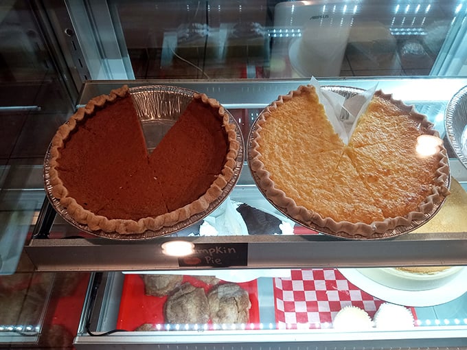 Pumpkin and sweet potato pies waiting patiently behind glass, like dessert celebrities ready for their close-up. Resistance is futile.