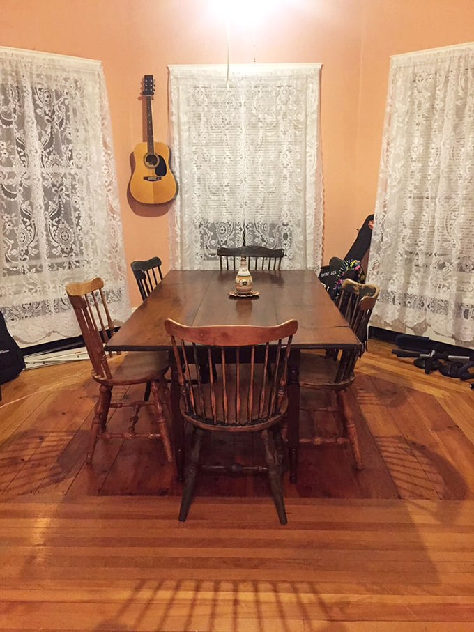 This rustic dining set isn't just furniture; it's a portal to family gatherings where stories flowed as freely as gravy.