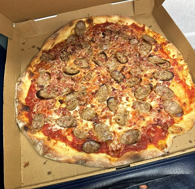 This sausage pizza isn't just food; it's edible architecture. The perfect ratio of crust to sauce to cheese to meat&mdash;a delicious equation solved.