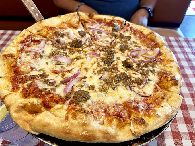 This isn't just pizza&mdash;it's a perfectly charred canvas where melted cheese, savory meat, and red onions perform a culinary ballet.