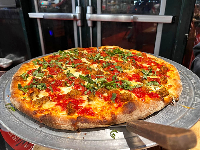 A pizza so beautiful it deserves its own Instagram account. That fresh basil isn't just garnish&mdash;it's the crown jewel of this masterpiece.
