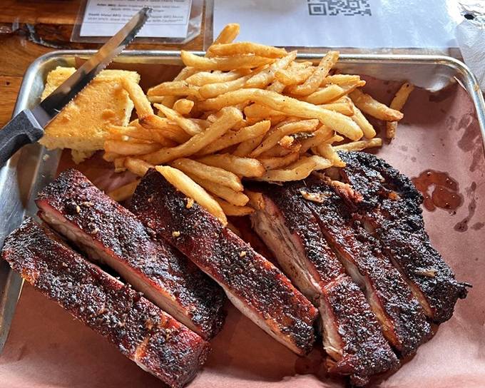 These ribs don't just fall off the bone—they practically leap into your mouth. The perfect bark, that smoke ring, and those fries? Pure Michigan magic.