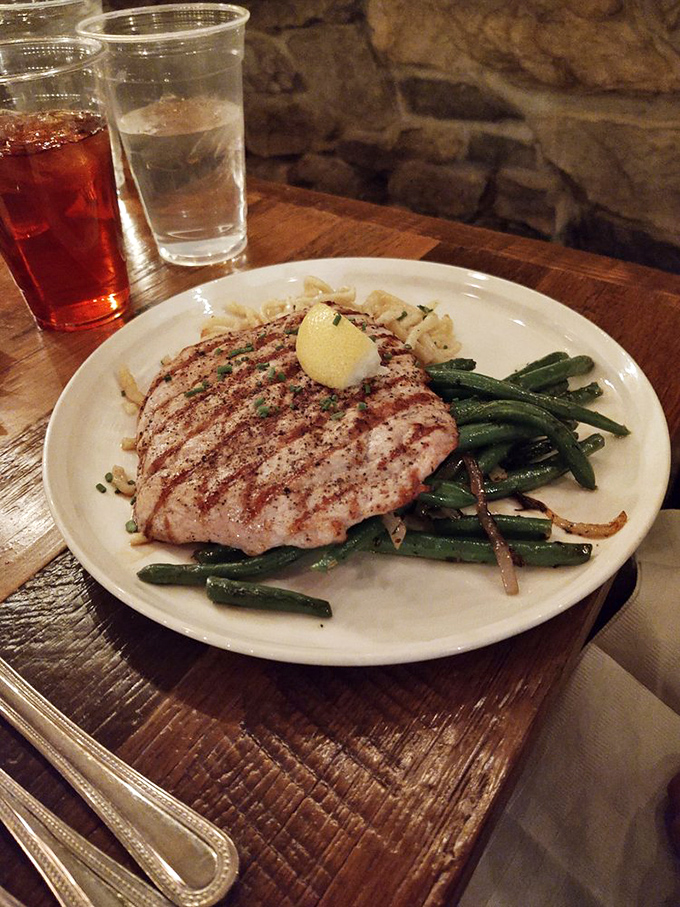 A perfectly grilled pork cutlet rests alongside vibrant green beans&mdash;proof that German cuisine isn't all about heaviness, though I wouldn't call it diet food either.