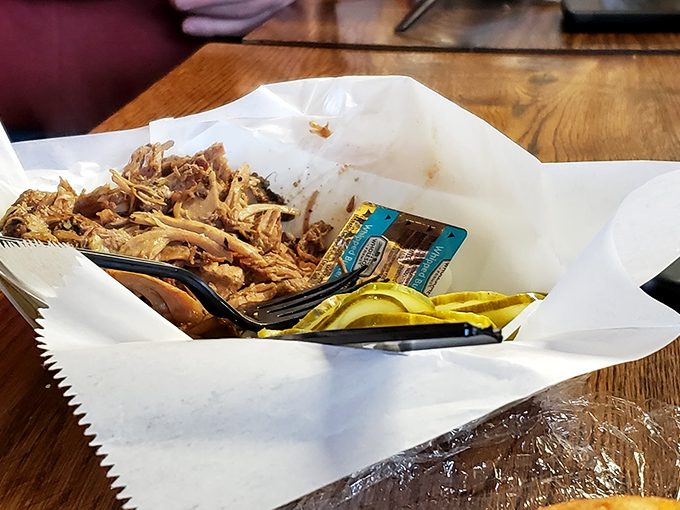 Behold the pork shoulder in all its glory&mdash;tender, pulled perfection nestled in butcher paper with pickle slices standing guard.