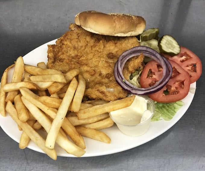 The legendary tenderloin in its natural habitat &ndash; a golden-brown disc of perfection that makes the bun look like it's wearing a meat sombrero.
