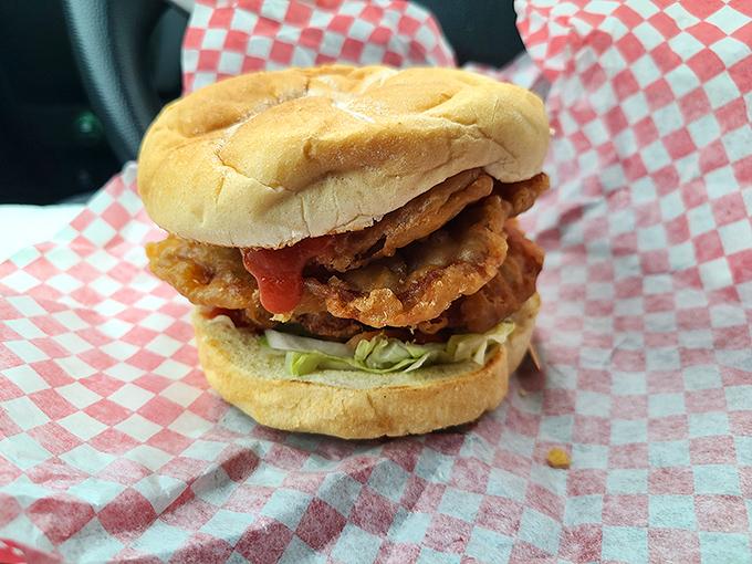 Behold the hero of our story: a golden-fried pork tenderloin that laughs at the concept of bun containment, dressed simply with fresh veggies.