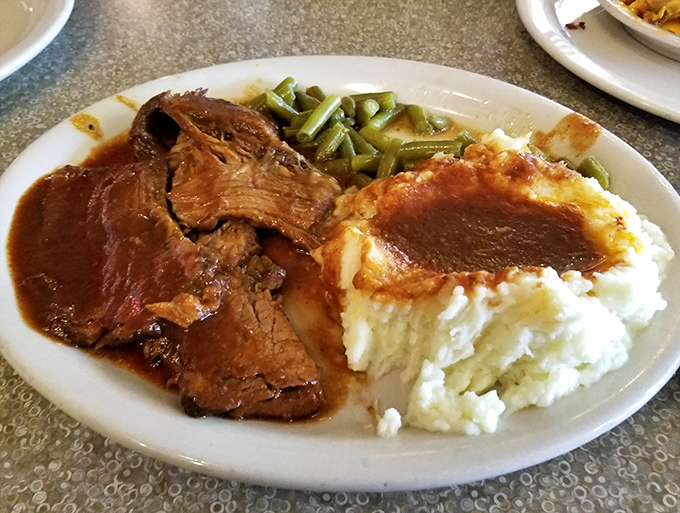 This isn't just pot roast; it's a tender masterpiece that falls apart with a stern look, swimming in gravy worth bottling.