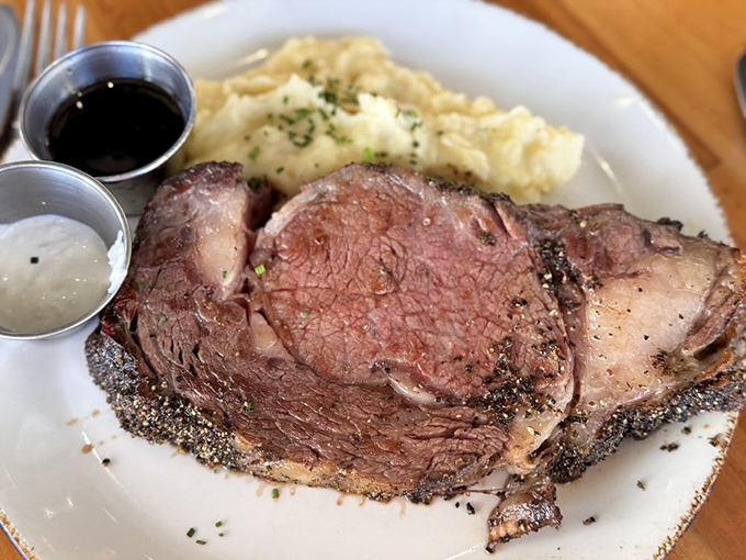 The prime rib arrives like a carnivore's dream &ndash; herb-crusted, perfectly pink, and accompanied by creamy mashed potatoes that could make a potato farmer weep.