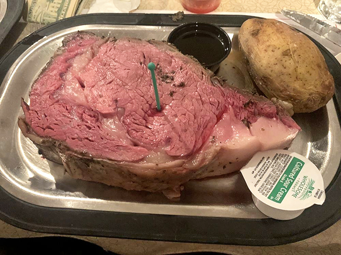 Meat masterpiece alert! This perfectly pink prime rib with its seasoned crust and accompanying baked potato is what food dreams are made of.