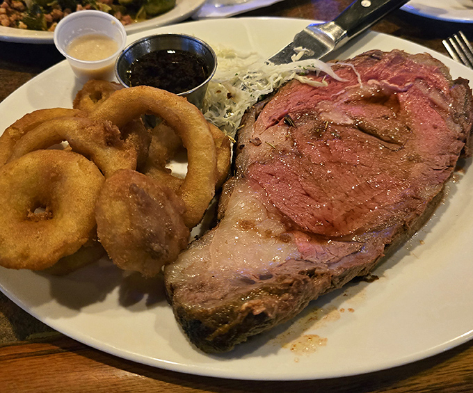 The prime rib arrives like a carnivore's dream&mdash;perfectly pink, accompanied by golden onion rings that shatter with satisfying crispness. This is meat worth writing home about.