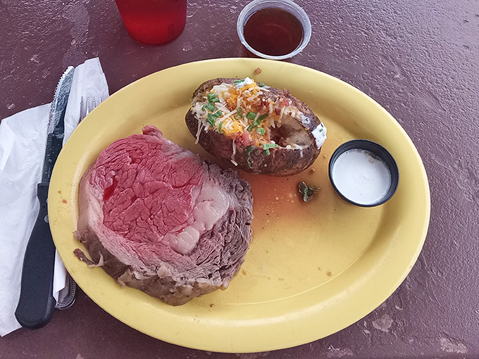The legendary prime rib in all its glory. Perfectly pink, fork-tender, and accompanied by a loaded baked potato – this is what food dreams are made of.