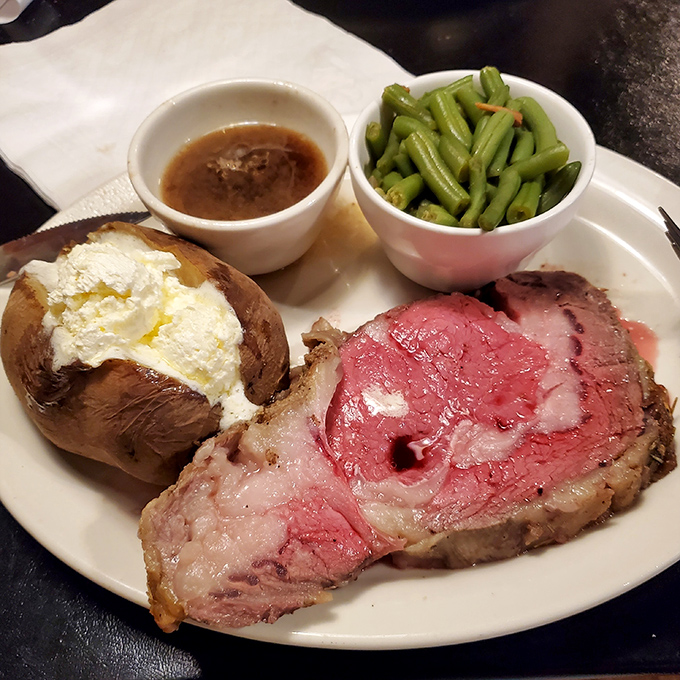 That prime rib arrives looking like it graduated summa cum laude from Beef University with honors.