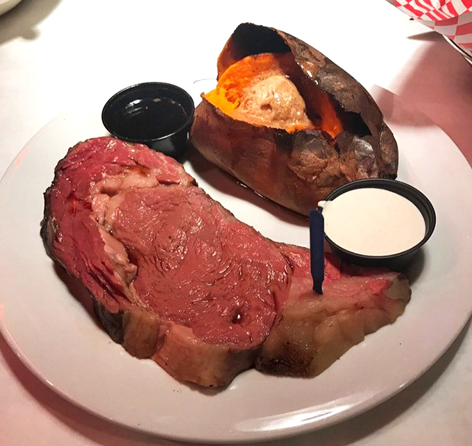 This prime rib isn't just dinner—it's a religious experience. Perfectly pink, impossibly tender, and served with a loaded baked potato that's a meal unto itself.