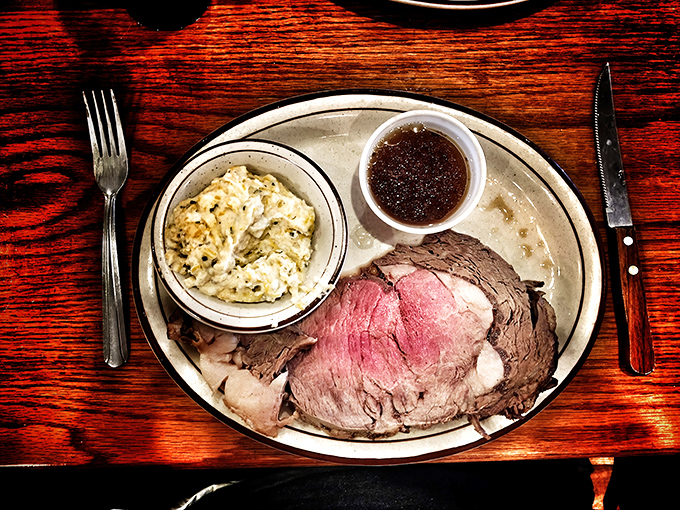 This prime rib isn't just dinner; it's a life-affirming experience. Perfectly pink, accompanied by creamy sides and that essential au jus for dunking.
