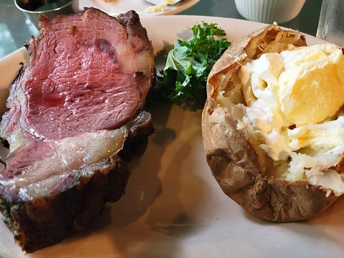 This prime rib isn't just cooked, it's been on a 14-hour journey to perfection, arriving at your table with a baked potato sidekick.