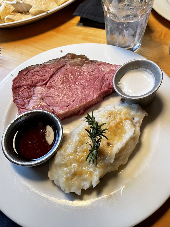 Prime rib perfection: that rosy center, that savory crust, that loaded potato sidekick. This isn't dinner; it's a religious experience with horseradish.