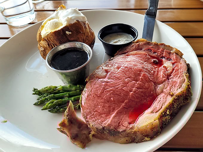 Behold the star of the show: prime rib so perfectly pink it should have its own Instagram account, accompanied by a loaded baked potato.