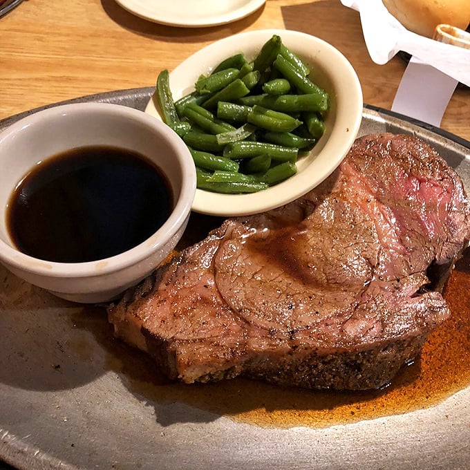A perfectly cooked steak with green beans and au jus &ndash; simple perfection that proves fancy plating is overrated when flavor does the talking.