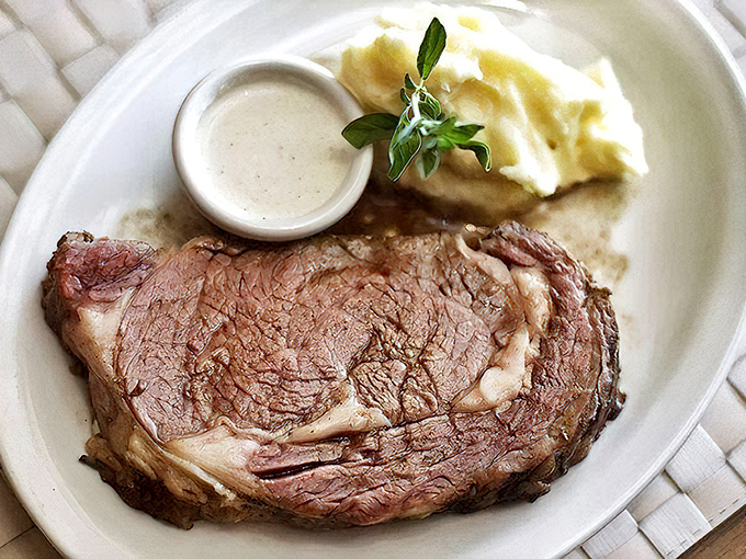 Behold the star of the show: prime rib so perfectly cooked it practically poses for its close-up, accompanied by cloud-like mashed potatoes.