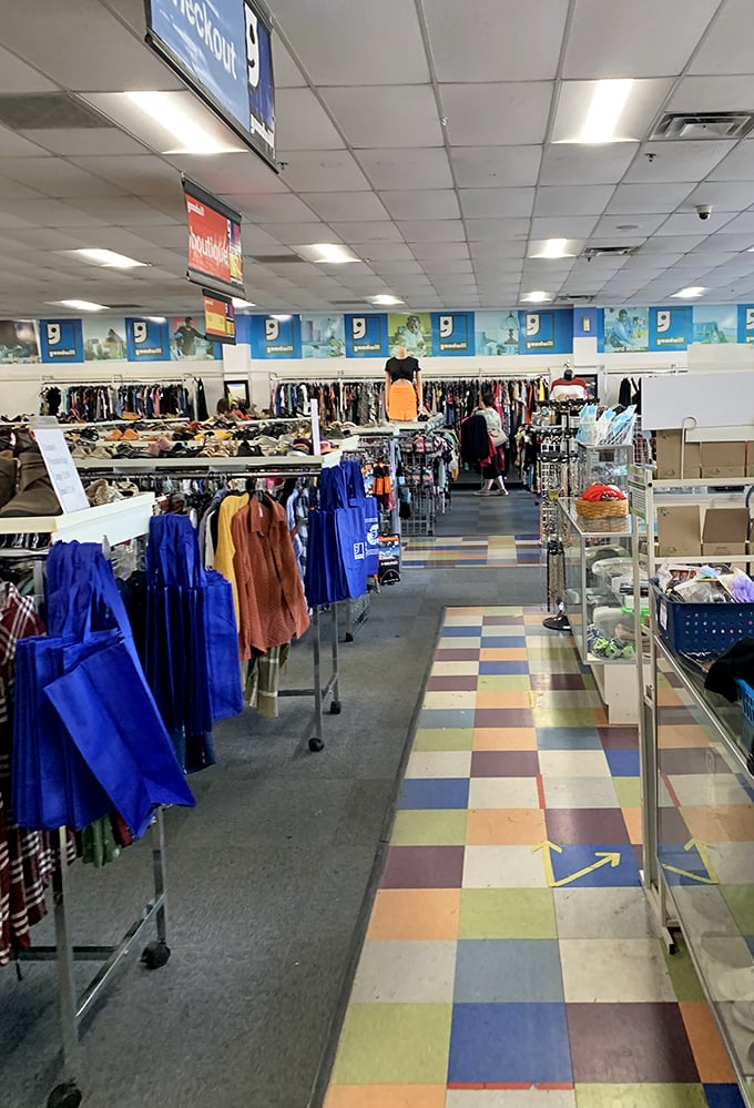 The colorful floor tiles lead you through a fashion forest where blue work shirts stand at attention like sentries guarding the path to vintage treasures.