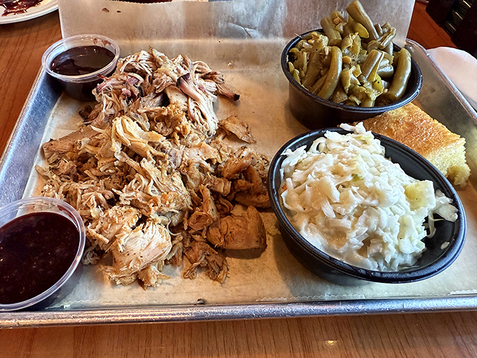 Pulled pork in its natural habitat, accompanied by proper Southern sides. This tray should come with a warning: "May induce involuntary food noises."