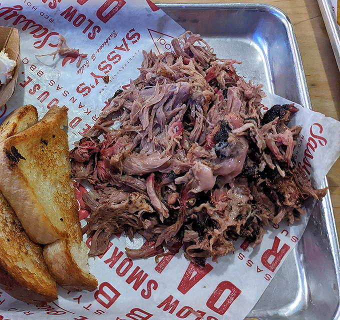 This pulled pork doesn't just fall apart—it practically surrenders to your fork after its 13-hour smoke bath, making every bite a tender triumph.