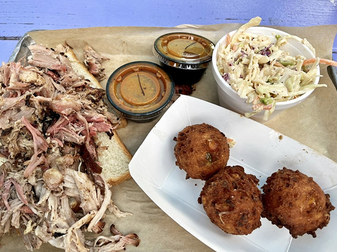 Pulled pork so tender it practically surrenders to your fork, served with hush puppies that crunch like edible exclamation points.