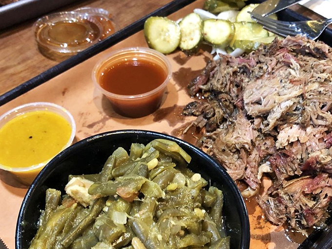 Green beans, pickles, and pulled pork sharing a tray &ndash; it's the barbecue equivalent of a perfect ensemble cast where every character gets their moment.