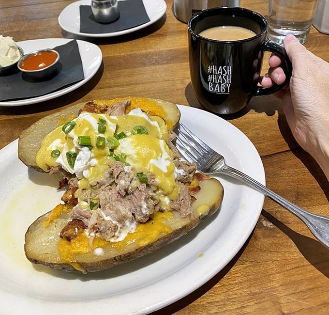 Pulled pork perfection atop a potato canvas. That hollandaise sauce cascading down like a yellow waterfall of happiness makes morning worth facing.