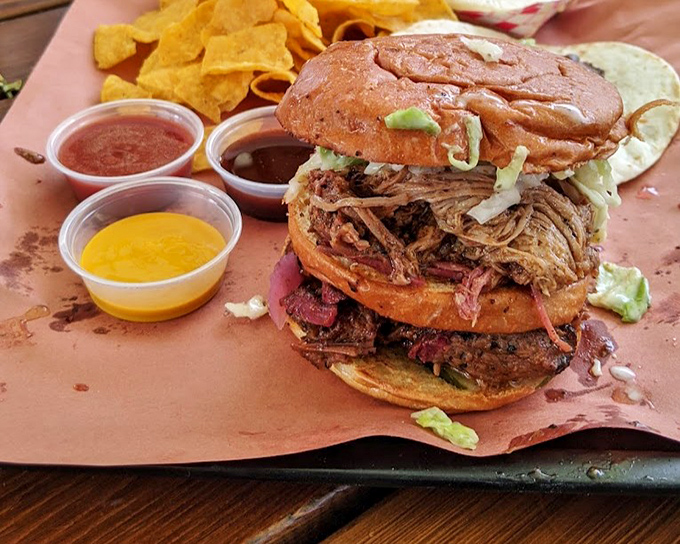 The sandwich that ruins all other sandwiches. Layers of smoky pulled pork and brisket create a tower of power that demands two hands and zero shame.