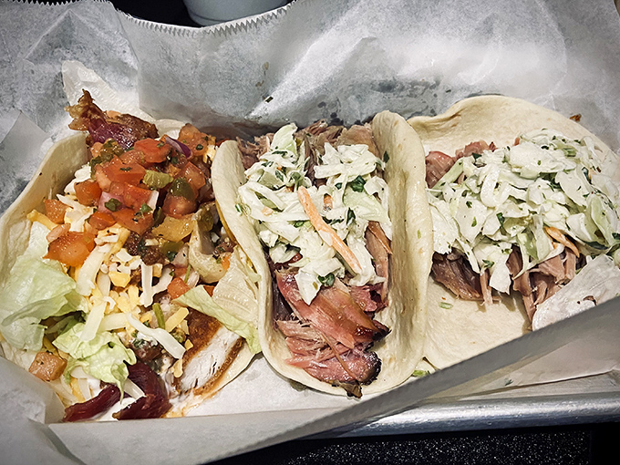 The holy trinity of tacos &ndash; pulled pork nestled in soft tortillas, topped with fresh slaw. This isn't fusion; it's barbecue evolution at its finest.
