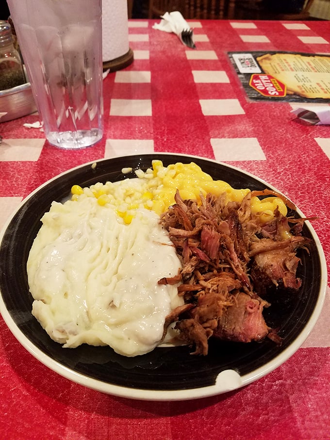 A plate that speaks the universal language of comfort - tender pulled pork alongside creamy mashed potatoes and sweet corn that tastes like summer.