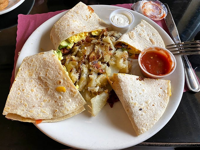 The star of the show in all its glory: a perfectly crisped quesadilla with home fries that have achieved that mythical balance of crisp exterior and fluffy interior.