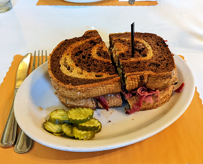 The legendary Reuben in all its glory&mdash;marble rye embracing corned beef in a warm hug while Swiss cheese plays matchmaker.