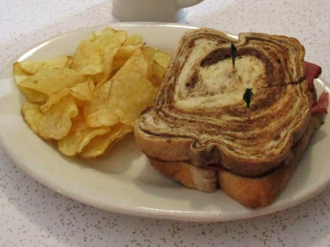 The Reuben arrives like a sandwich celebrity, perfectly grilled marble rye framing layers of corned beef and sauerkraut in a delicious autograph-worthy performance.