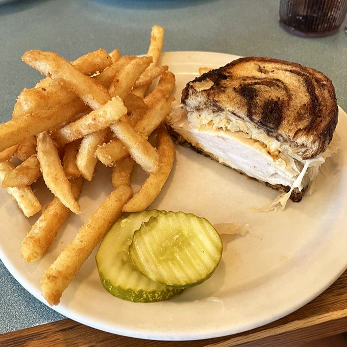 The Reuben that launched a thousand road trips. Perfectly grilled marble rye, sauerkraut with attitude, and corned beef that doesn't know the meaning of "skimpy."
