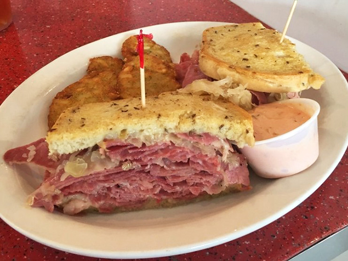Behold the Reuben in all its glory&mdash;layers of corned beef stacked higher than a Nashville songwriter's ambitions, with sauerkraut and Swiss playing perfect harmony.