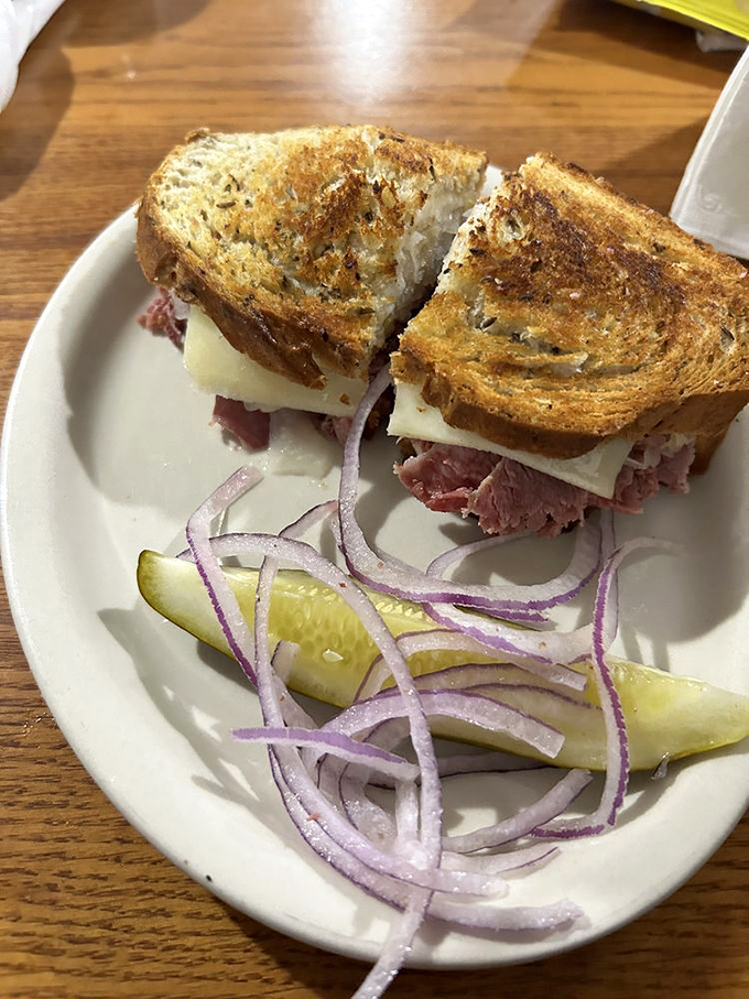 Behold the architectural marvel that is a proper Reuben&mdash;perfectly grilled rye, tender corned beef, and Swiss cheese with the obligatory pickle spear standing guard.