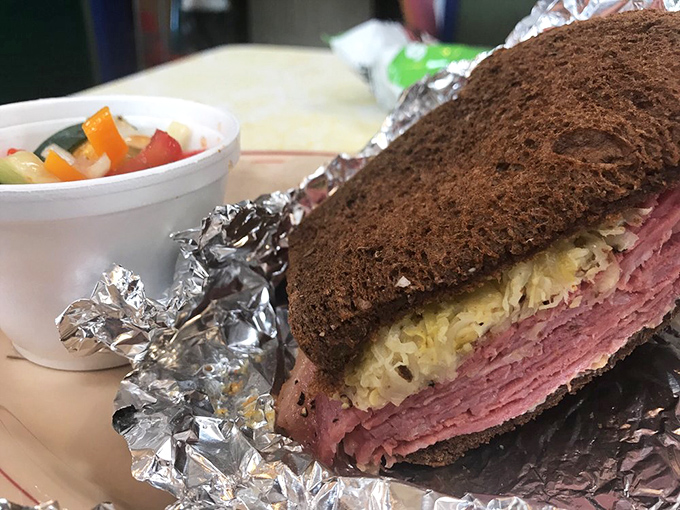 This isn't just a sandwich; it's a skyscraper of pastrami demanding respect and multiple napkins. The side of fresh vegetables provides the illusion of healthfulness.