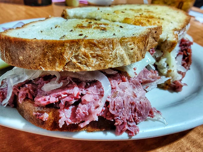 Behold the star attraction: layers of corned beef, sauerkraut, and Swiss on perfectly grilled rye. This isn't just a sandwich; it's architecture with flavor.