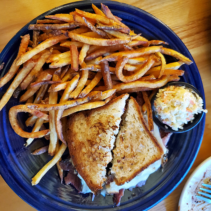 Behold the star attraction: a Reuben sandwich that doesn't just satisfy hunger&mdash;it creates memories, with golden fries standing by for supporting-actor duties.