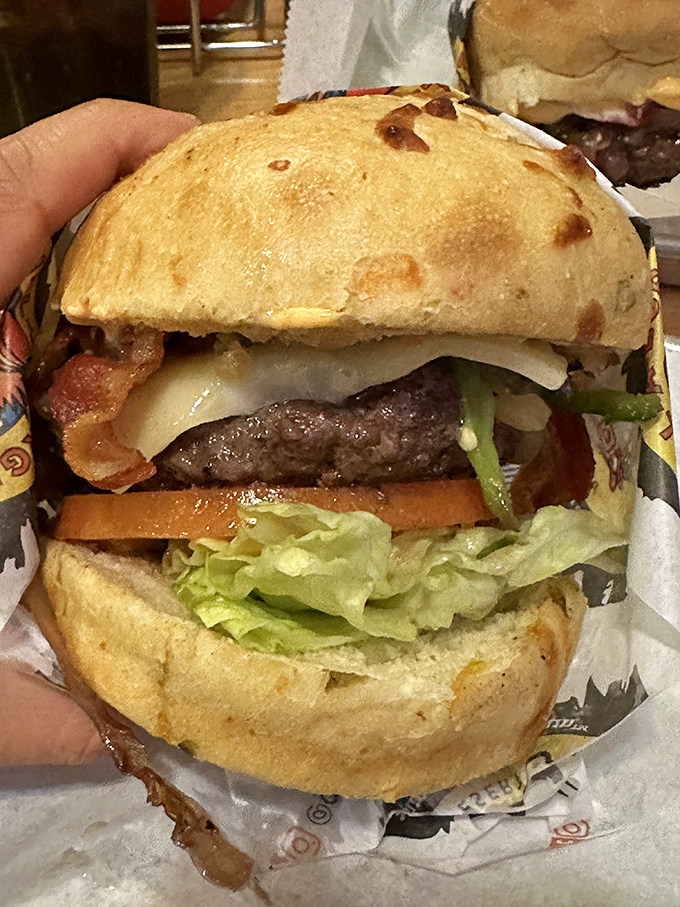 Architectural perfection between two buns. This isn't just a burger&mdash;it's edible engineering with bacon as the structural support.