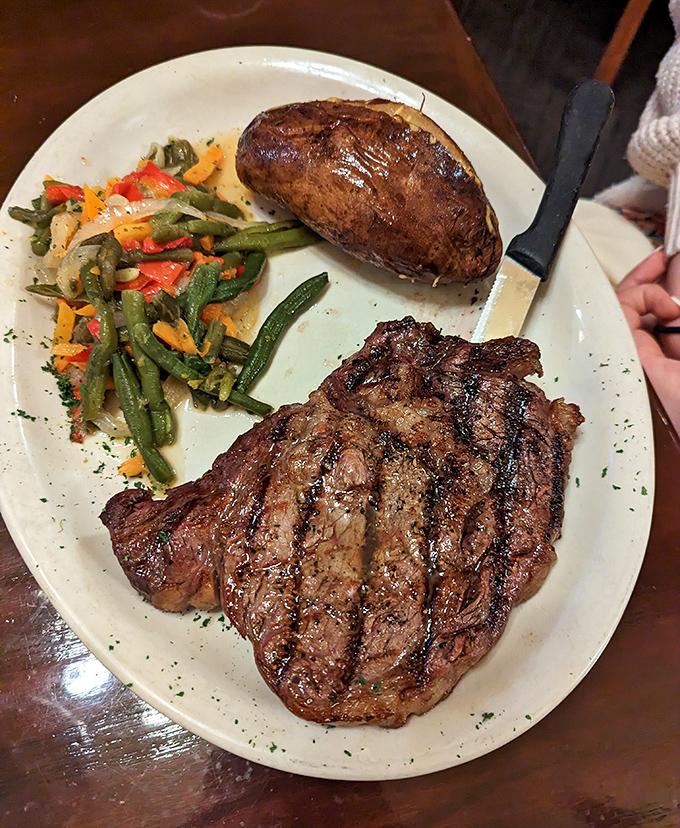 Behold the star of the show&mdash;a perfectly seared ribeye with textbook grill marks that whisper, "This is why you drove all this way."
