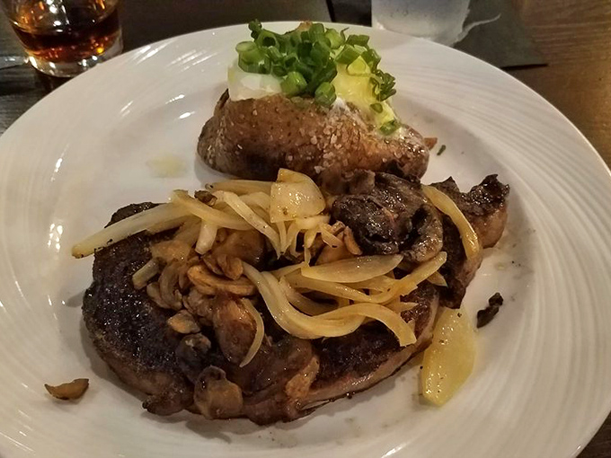 That ribeye with caramelized onions is what happens when a steakhouse respects both the beef and your taste buds.